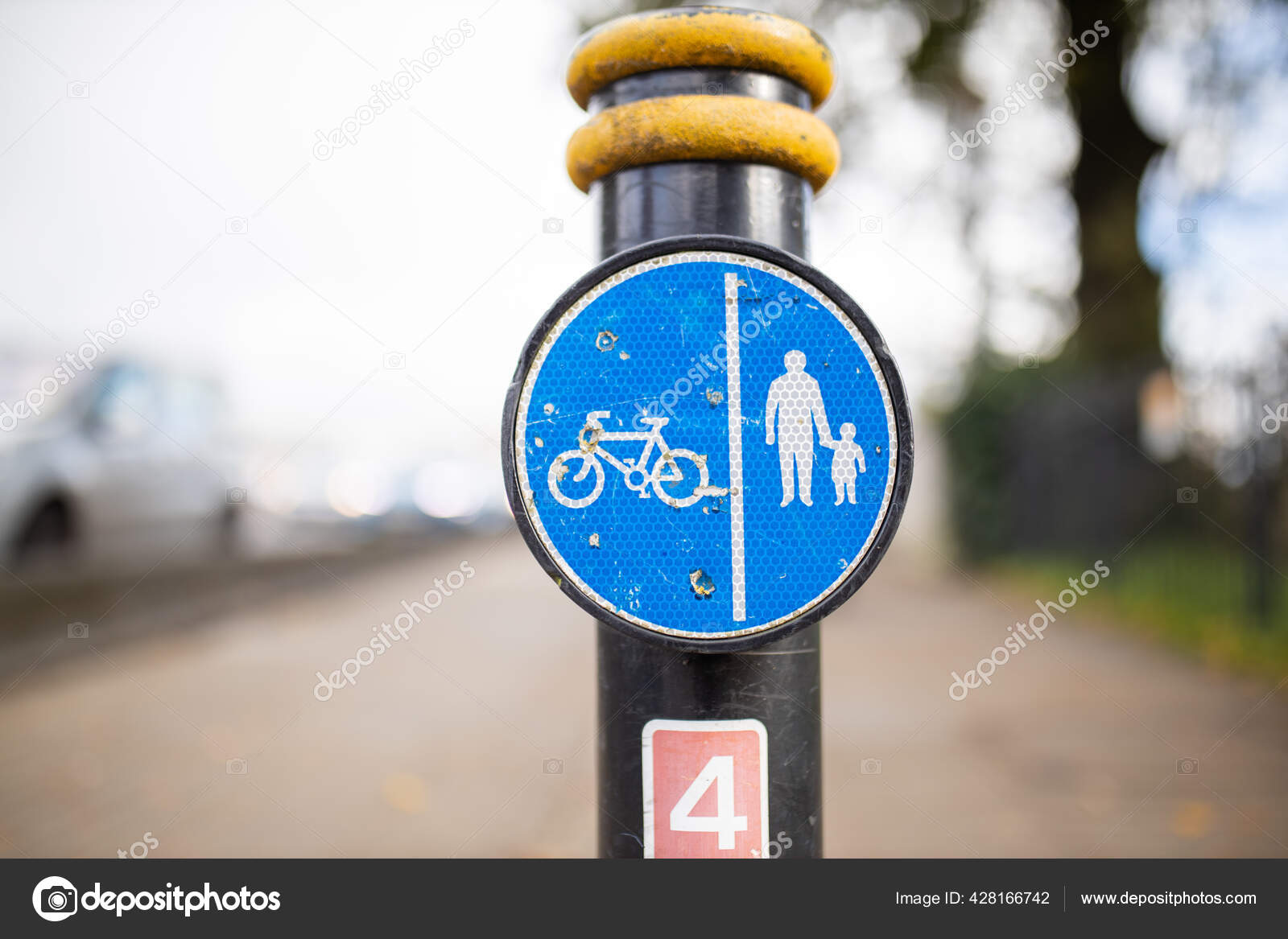 Blue sign on a pole indicating the pedestrians and cyclists paths Stock ...