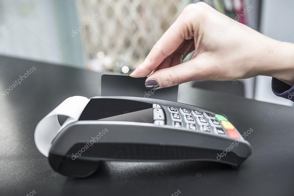 Debit card swiping on pos terminal. Stock Photo by ©believeinme 100812918