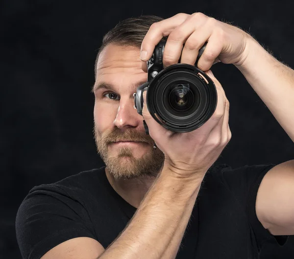 Young pro photographer with digital camera — Stock Photo © lightpoet ...