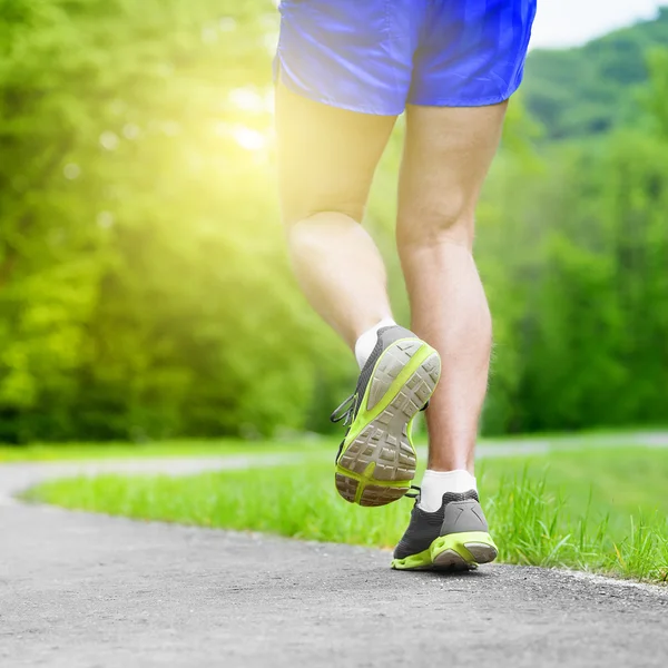 Athlete runner feet running on road. - Stock Image - Everypixel