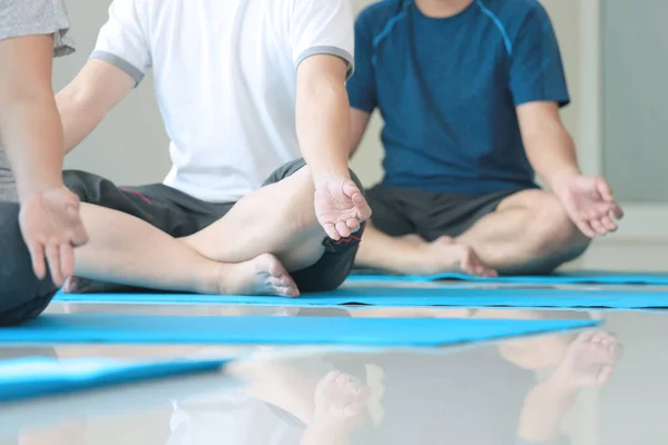 Group of meditation of students and teacher practicing relaxation of ...