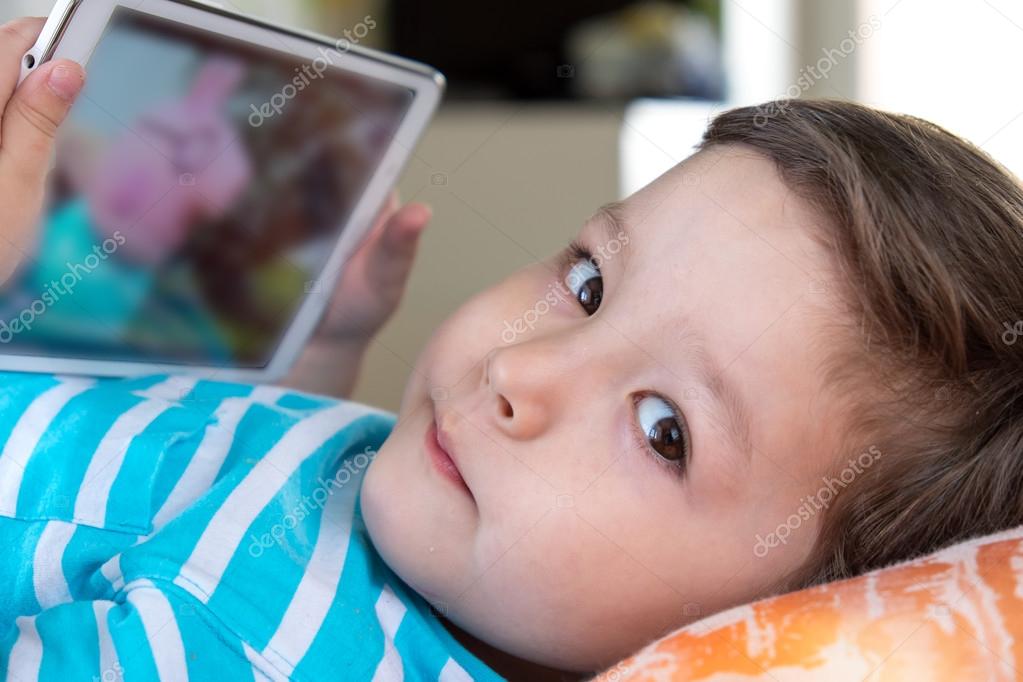 The boy is with tablet and play games — Stock Photo © sasha1806 #102307100