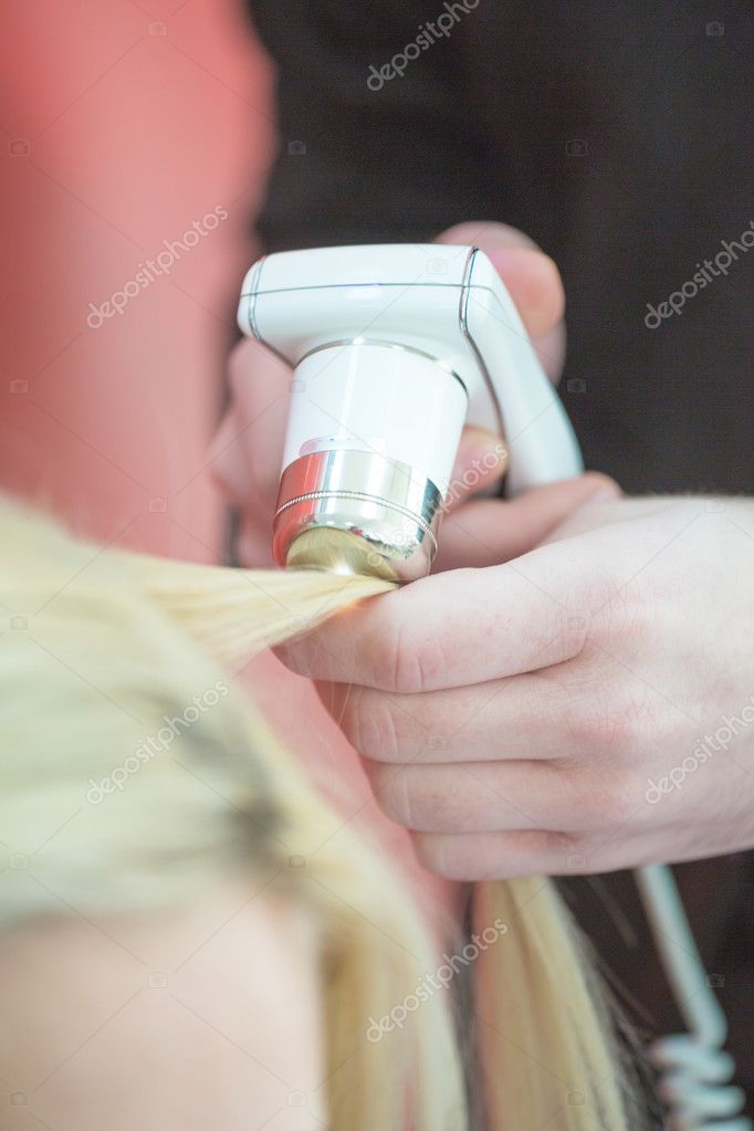 Hair treatment. hair testing. man's hand with the device for tes ...