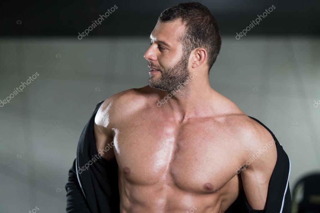 Ripped Young Man In Modern Fitness Center — Stock Photo © ibrak #113209404
