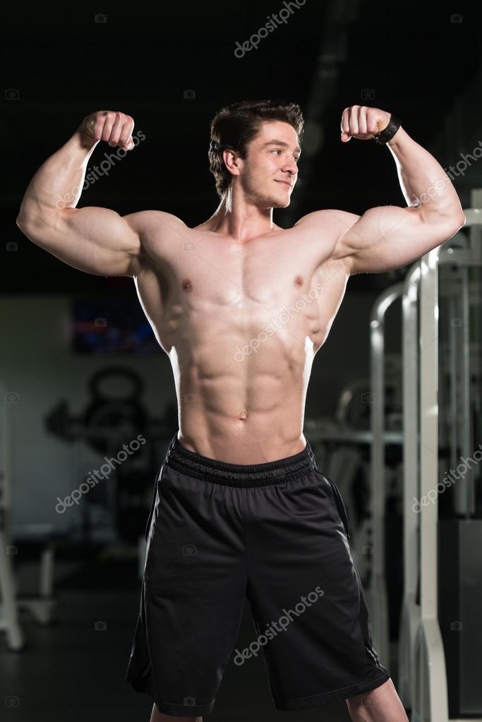 Bodybuilder Performing Front Double Biceps Pose In Gym — Stock Photo ...