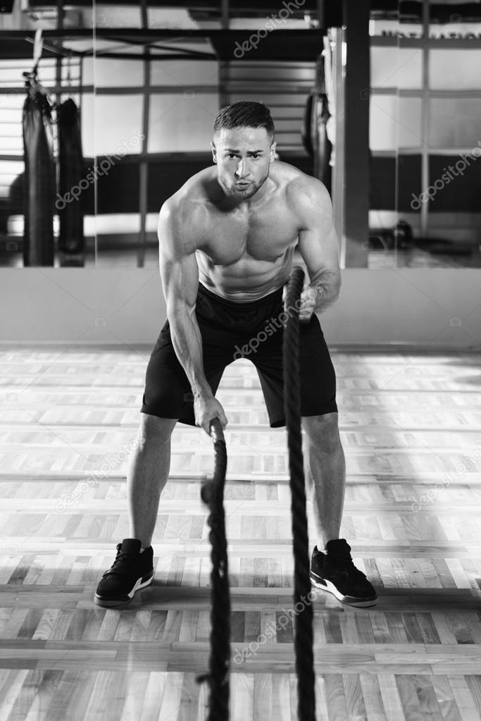 Young Man Battling Ropes At Gym Workout Exercise — Stock Photo © ibrak ...