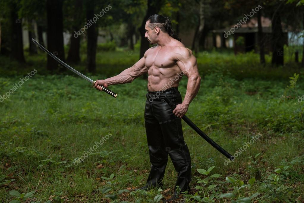 Muscular Man Holding Ancient Sword Stock Photo by ©ibrak 56832909