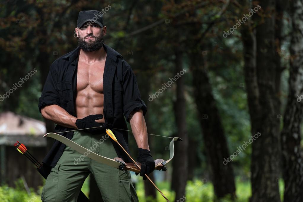 Man With A Bow And Arrows In Woods — Stock Photo © ibrak #56847039