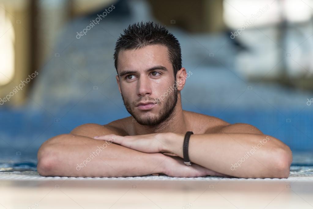 Man Resting His Arms At Edge Of Pool — Stock Photo © ibrak #60177013