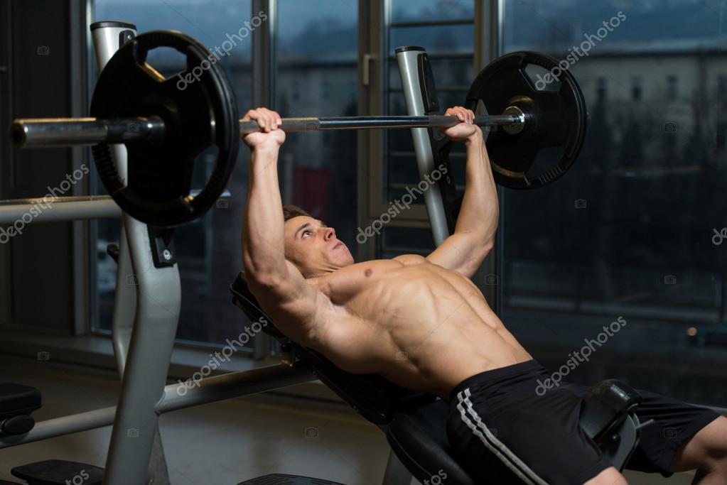 Young Man Doing Bench Press Exercise For Chest — Stock Photo © ibrak ...
