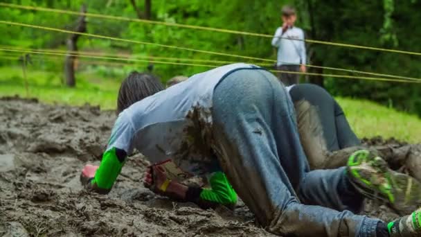Woman crawling through mud — Stock Video © probakster #97485154