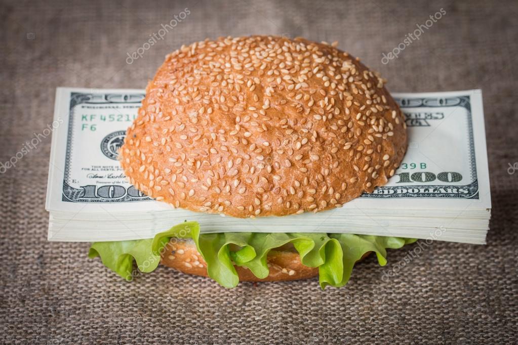 Hamburger with dollar bank notes — Stock Photo © Roxiller #69586419