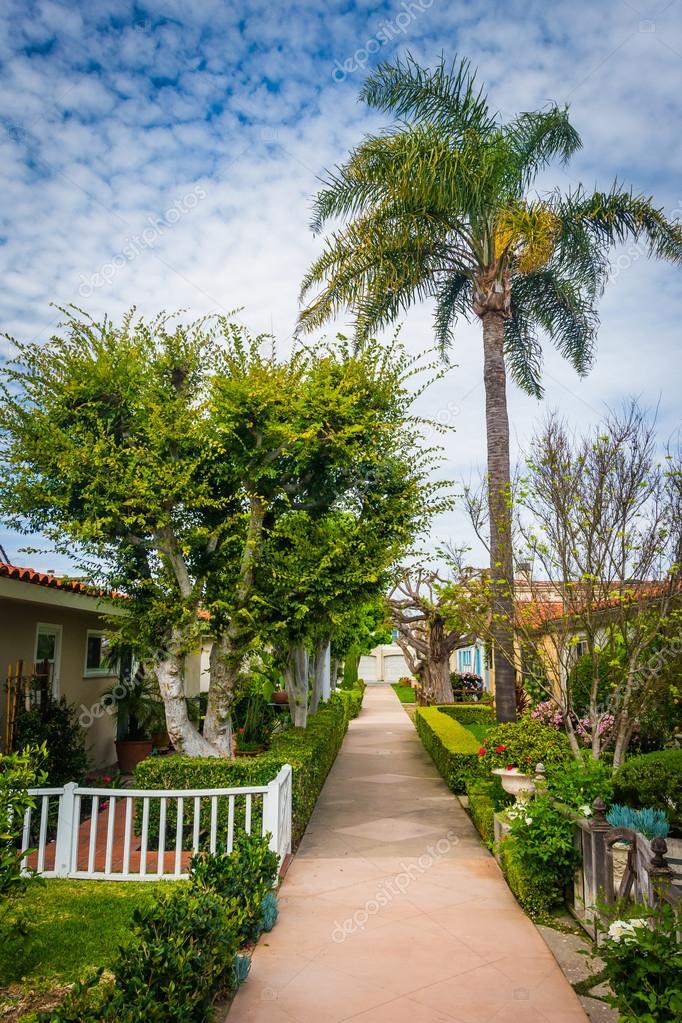 Gardens and houses along walkway, on Lido Isle, in Newport Beach ...