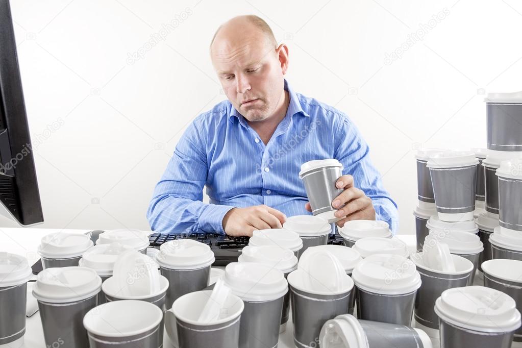 Overworked businessman drinking too much coffee — Stock Photo © kjekol ...