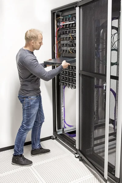 IT consultant build network rack in datacenter - Stock Image - Everypixel