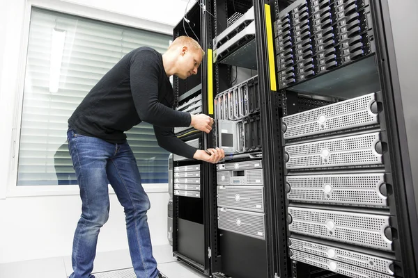 IT engineer installs blade server in datacenter - Stock Image - Everypixel