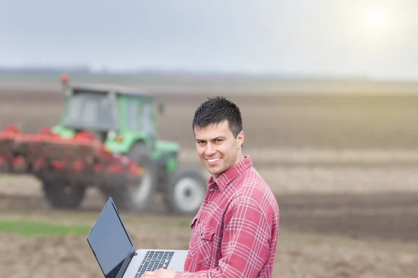 Farmer with laptop on field Stock Photo by ©budabar 67259075