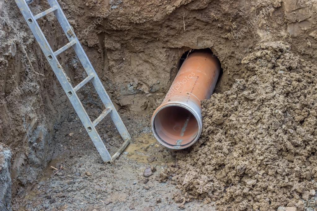 Installing pipes under the road Stock Photo by ©kataklinger 53471871