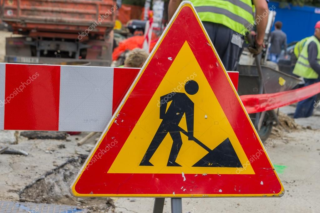 Traffic sign for construction works in street and workers 3 — Stock ...