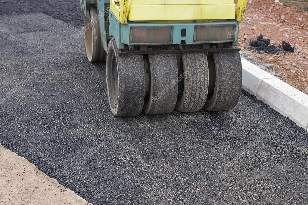 Patching asphalt at road construction site Stock Photo by ©kataklinger ...