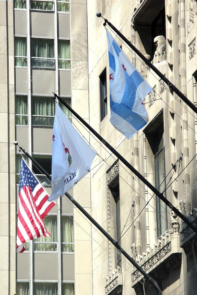 American and local state flags flying outside government building ...