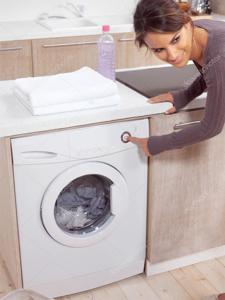 Female pressing button on washing machine — Stock Photo © toocan #58407209