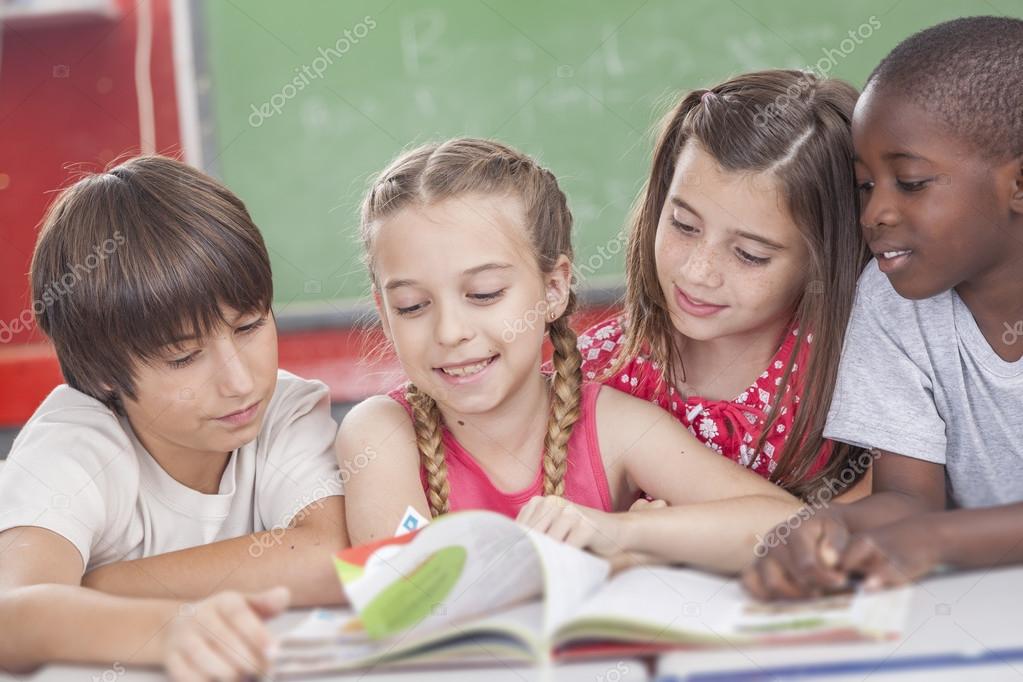Pupils reading at school — Stock Photo © Implementar #93986518
