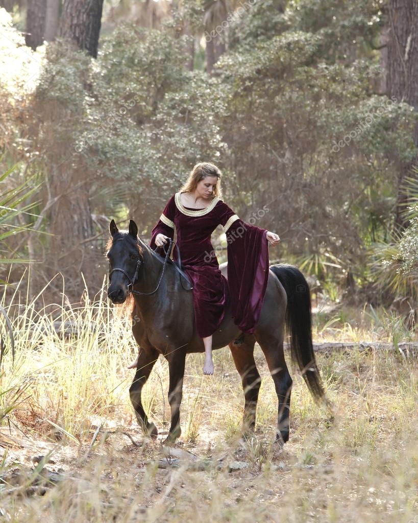 Medieval woman riding horse in forest Stock Photo by ©Wollwerth 62902243