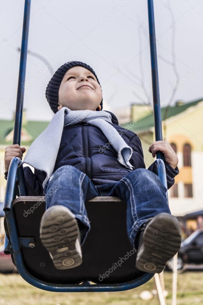 Boy riding on a swing — Stock Photo © mikitiger #67417267