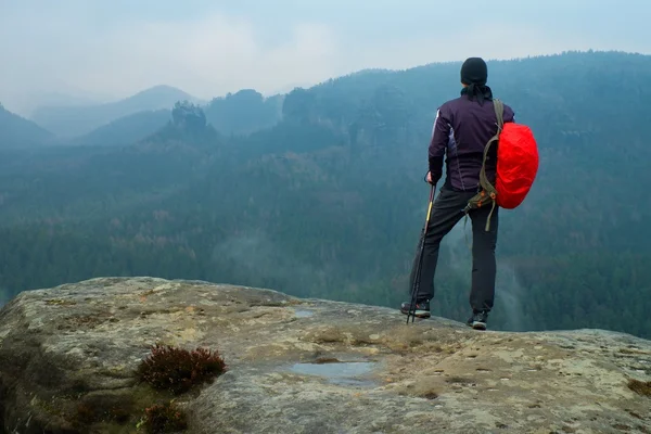 Hiker with red backpack on sharp sandstone rock in rock empires park ...