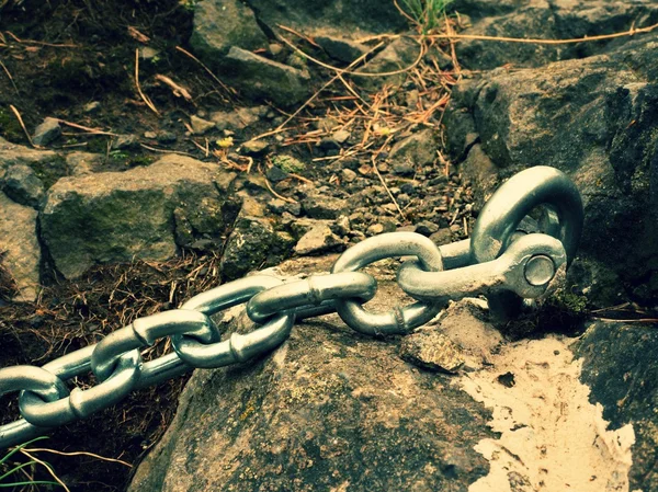 Detail of steel bolt anchor eye in rock. The end knot of steel rope ...