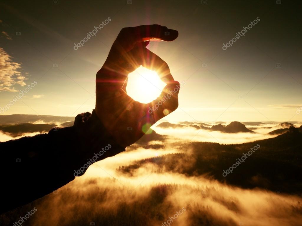 Man hand touch Sun. Misty daybreak in a beautiful hills. — Stock Photo ...