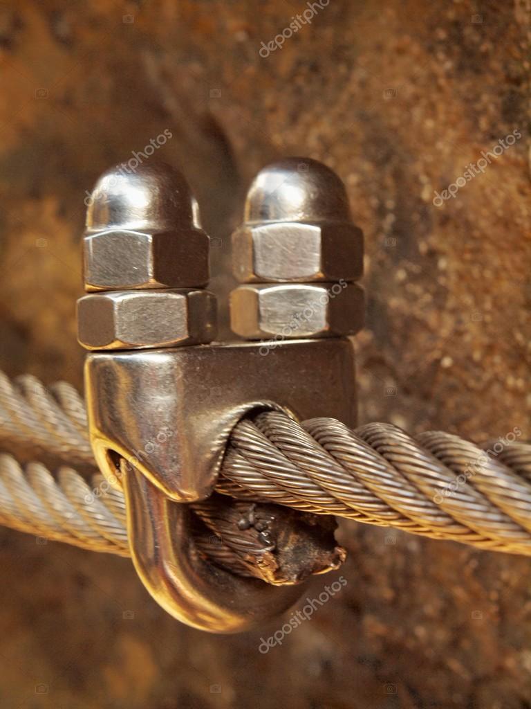 Climbers way. Iron twisted rope fixed in block by screws snap hooks ...