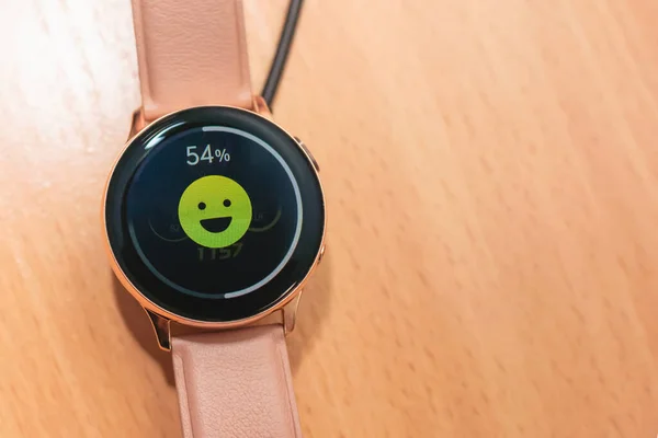 Smartwatch charging.Smart watch on wireless charging with on-screen ...