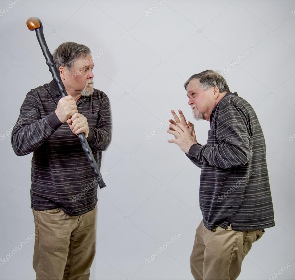 One twin senior about to strike the other with his cane Stock Photo by ...