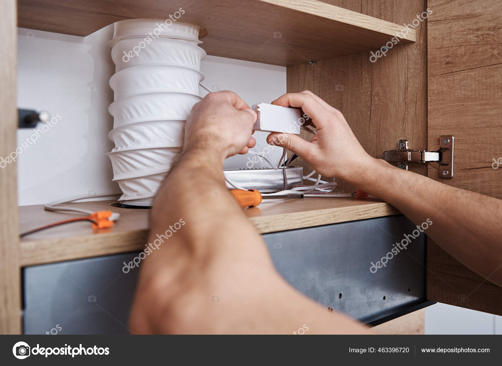 Connecting wiring in the kitchen cabinet Stock Photo by ©Shtak3t 463396720
