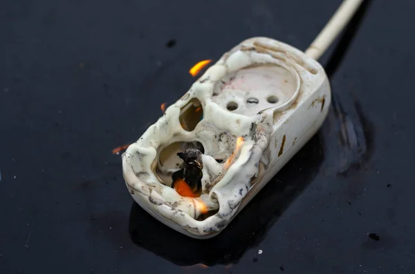 Household electrical appliance fire concept. Initial stage of power ...