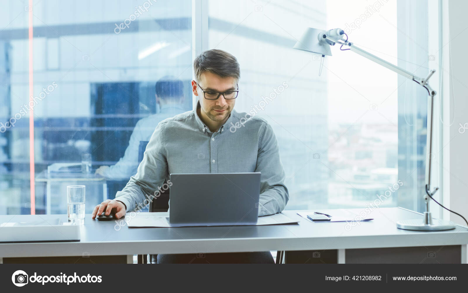 Successful Young Businessman Works on a Laptop in His Modern Office ...