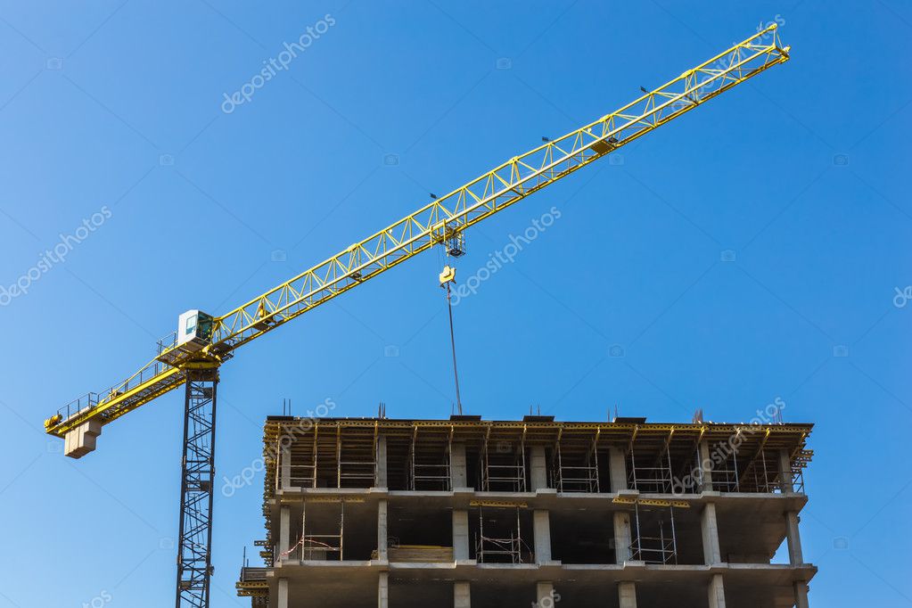 Construction crane on building site on sky background #55513391 - Larastock