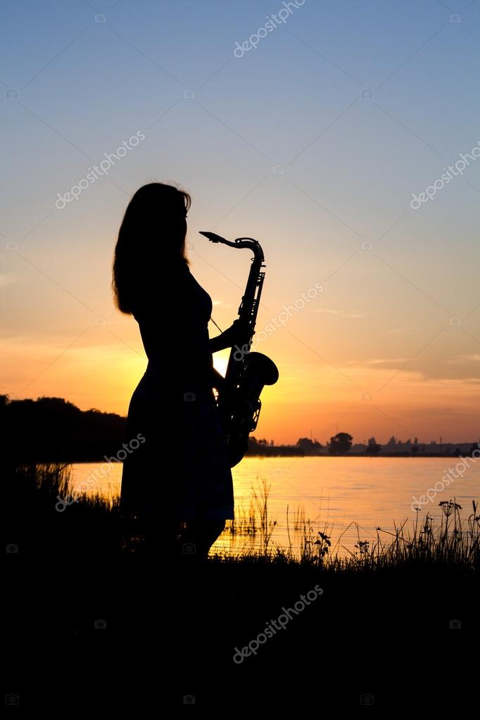 Girl with a brass musical instrument into the distance Stock Photo by ...