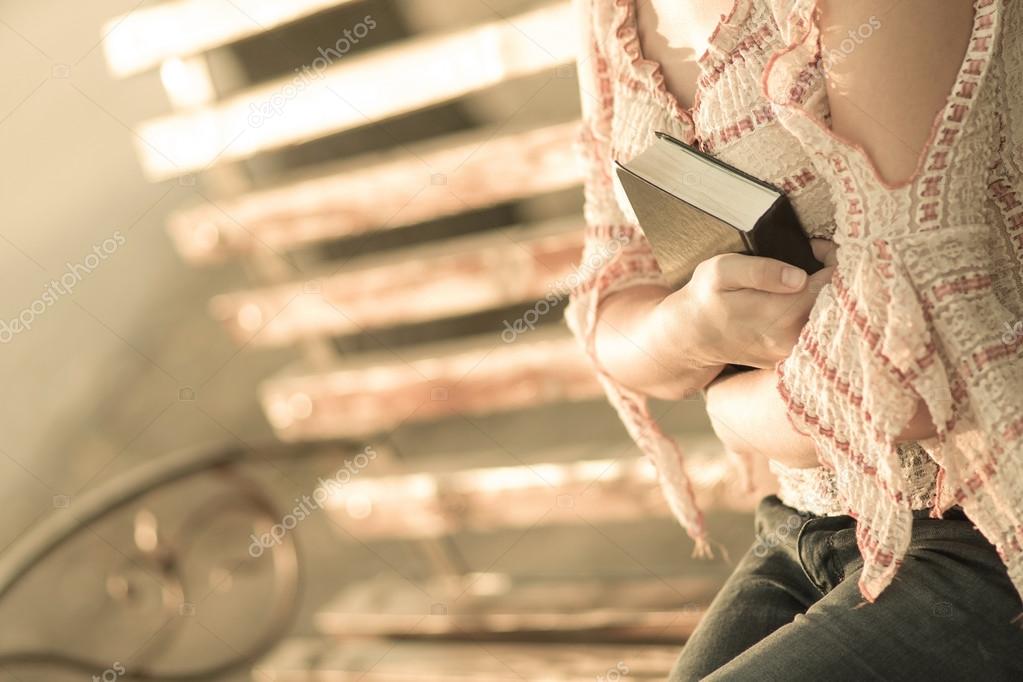 Woman hugging a book on a bench — Stock Photo © fantom_rd #85640266