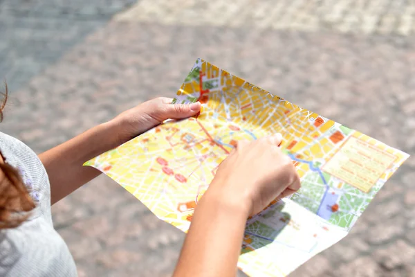 Pretty young female tourist studying a map - Stock Image - Everypixel