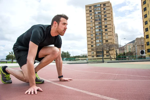 Man ready to run on the track - Stock Image - Everypixel