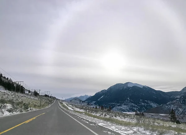 Halo around the sun on a winter day. Fraser Valley in winter. Road and ...