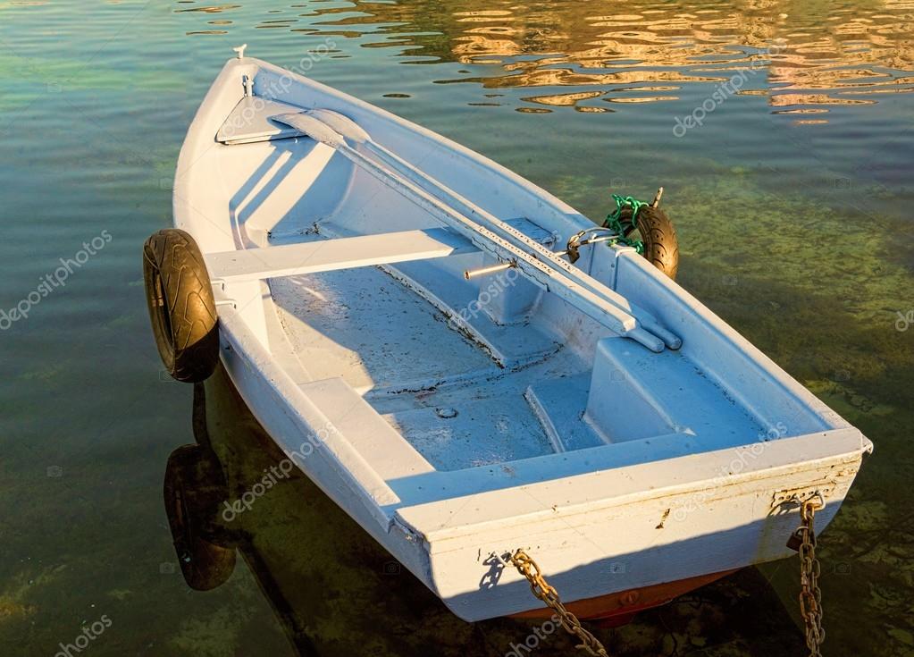 Small rowing boat with two old tires — Stock Photo © philipimage #61854015