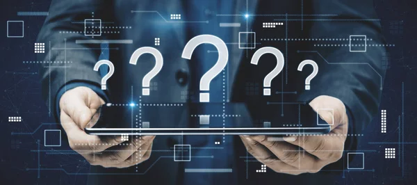 Businessman hands holding tablet with creative glowing question marks interface on dark ...