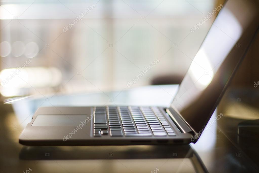Modern laptop on glass table Stock Photo by ©peshkov 70814659