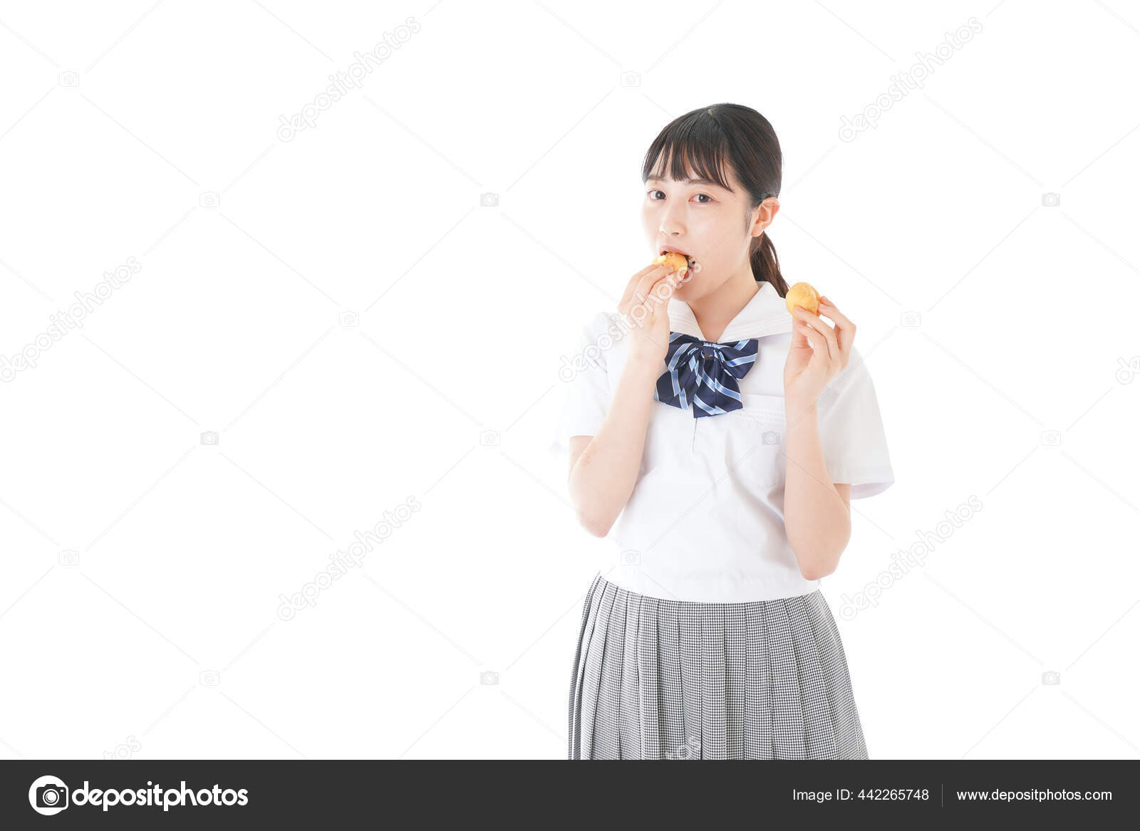 Uniformed Young Student Eating Snack Studying — Stock Photo © maroke ...