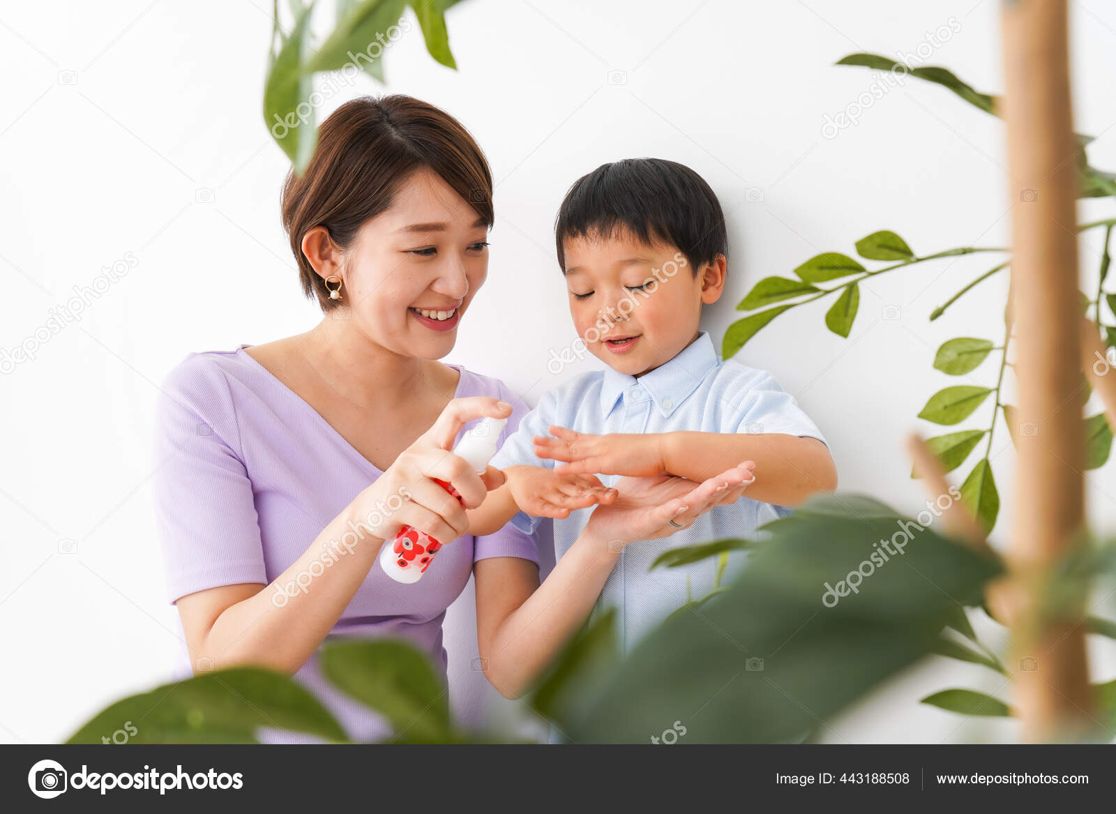 Mother Using Spray Sanitize Hands Her Child Stock Photo by ©maroke 443188508