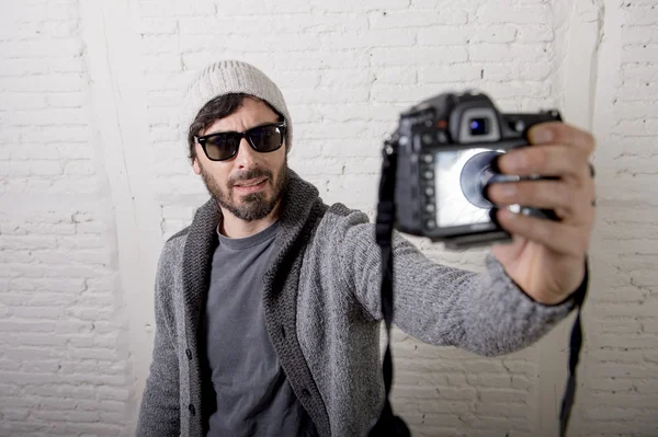 young blogger man hipster style holding photo camera shooting selfie ...